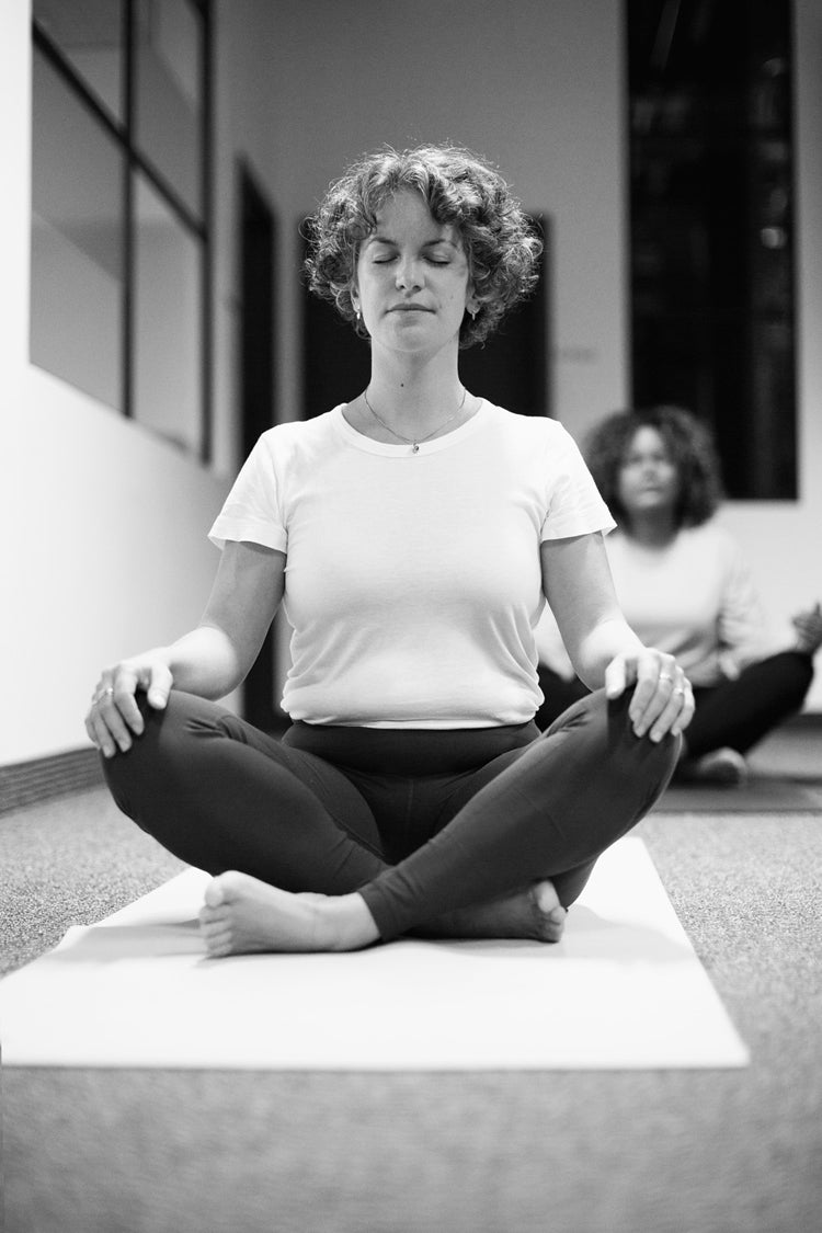Person meditating on yoga mat – pre&ent
